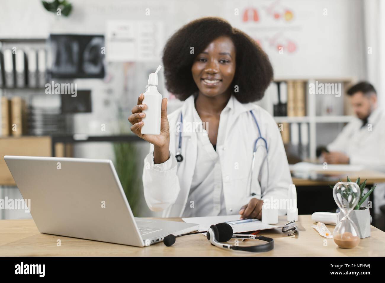 African american female doctor holding various medication in hands and ...
