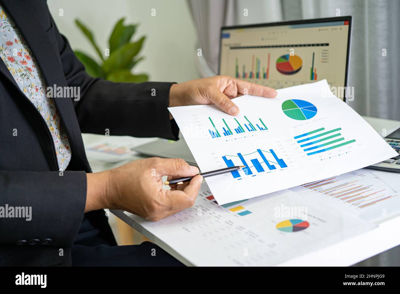 Asian accountant working and analyzing financial reports project ...