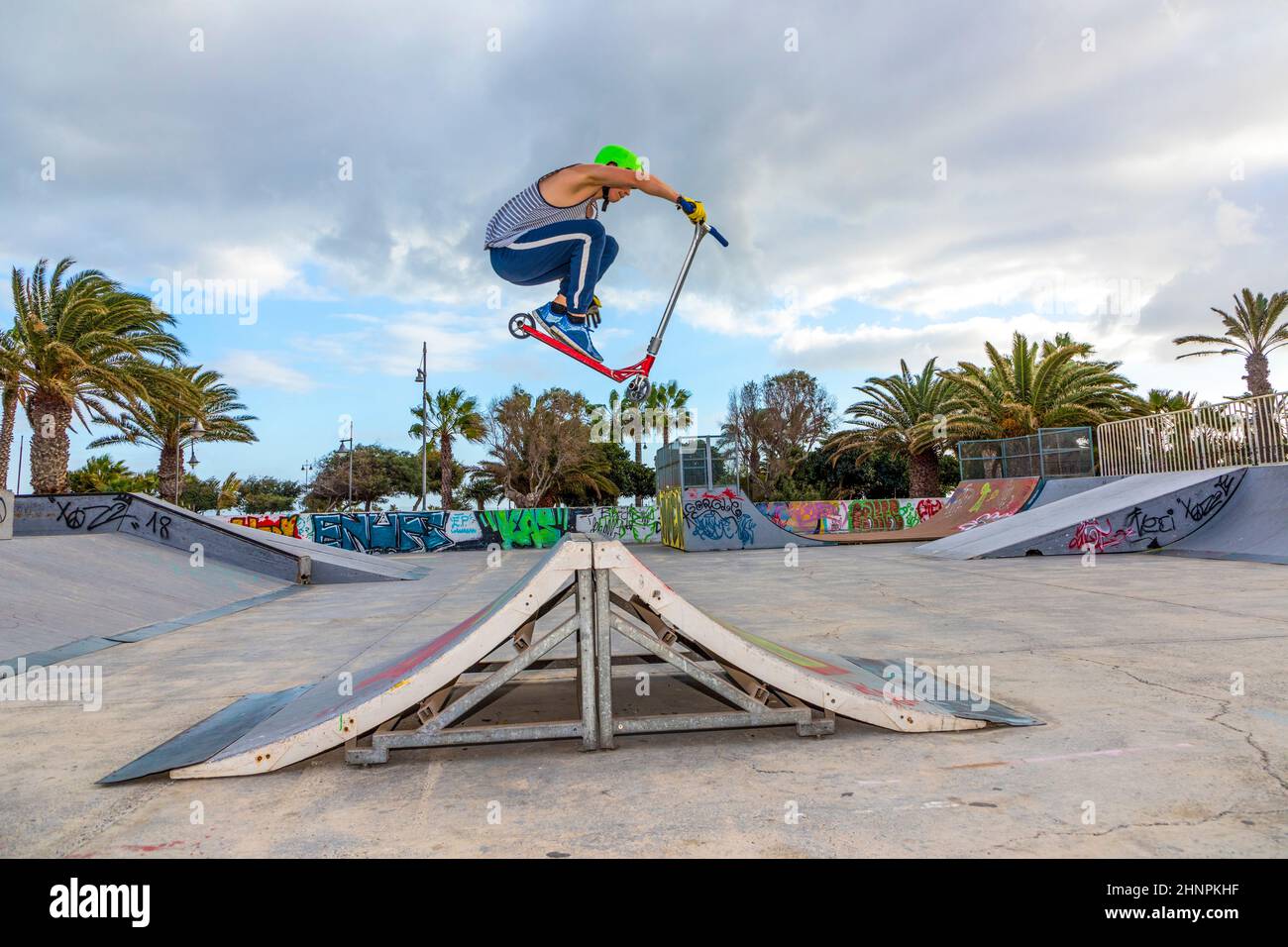 boy jumping at the skate park over a ramp Stock Photo - Alamy