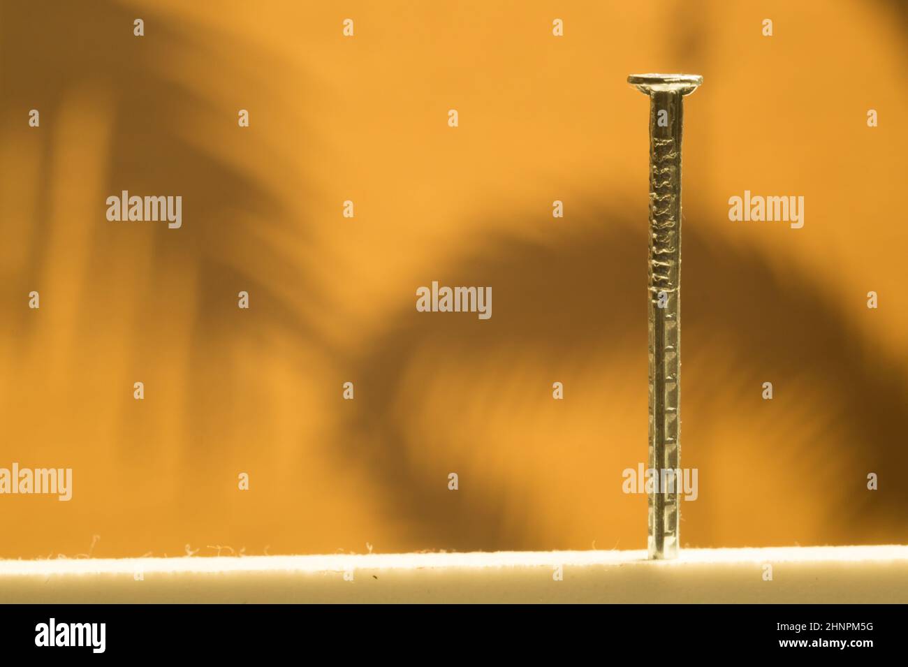 Small metal nail isolated background Stock Photo - Alamy
