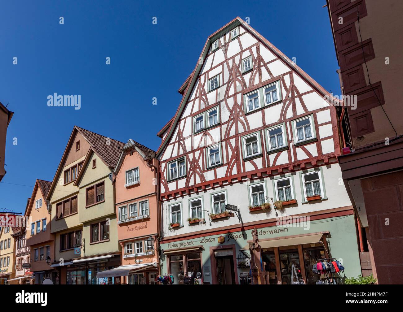 people visit the pedestrian zone of the scenic medieval village of ...