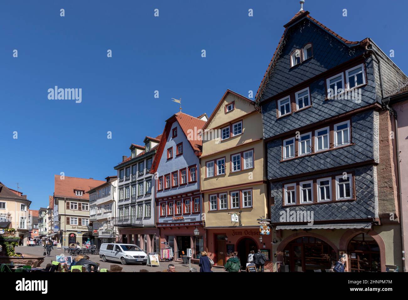 people visit the pedestrian zone of the scenic medieval village of ...