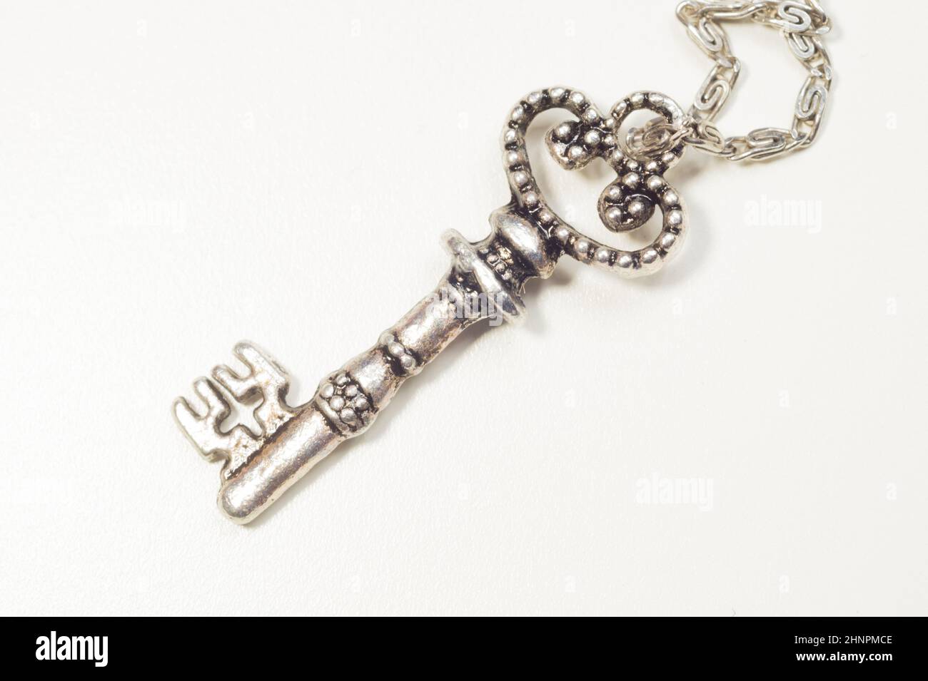 Vintage key with the chain isolated on white background. safety and ...