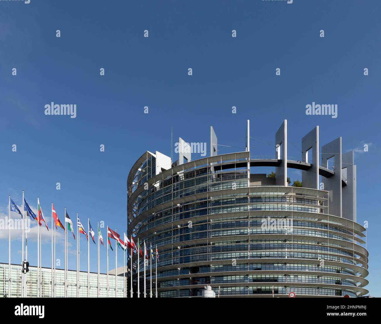 modern architecture of european union parliament with flags of members ...