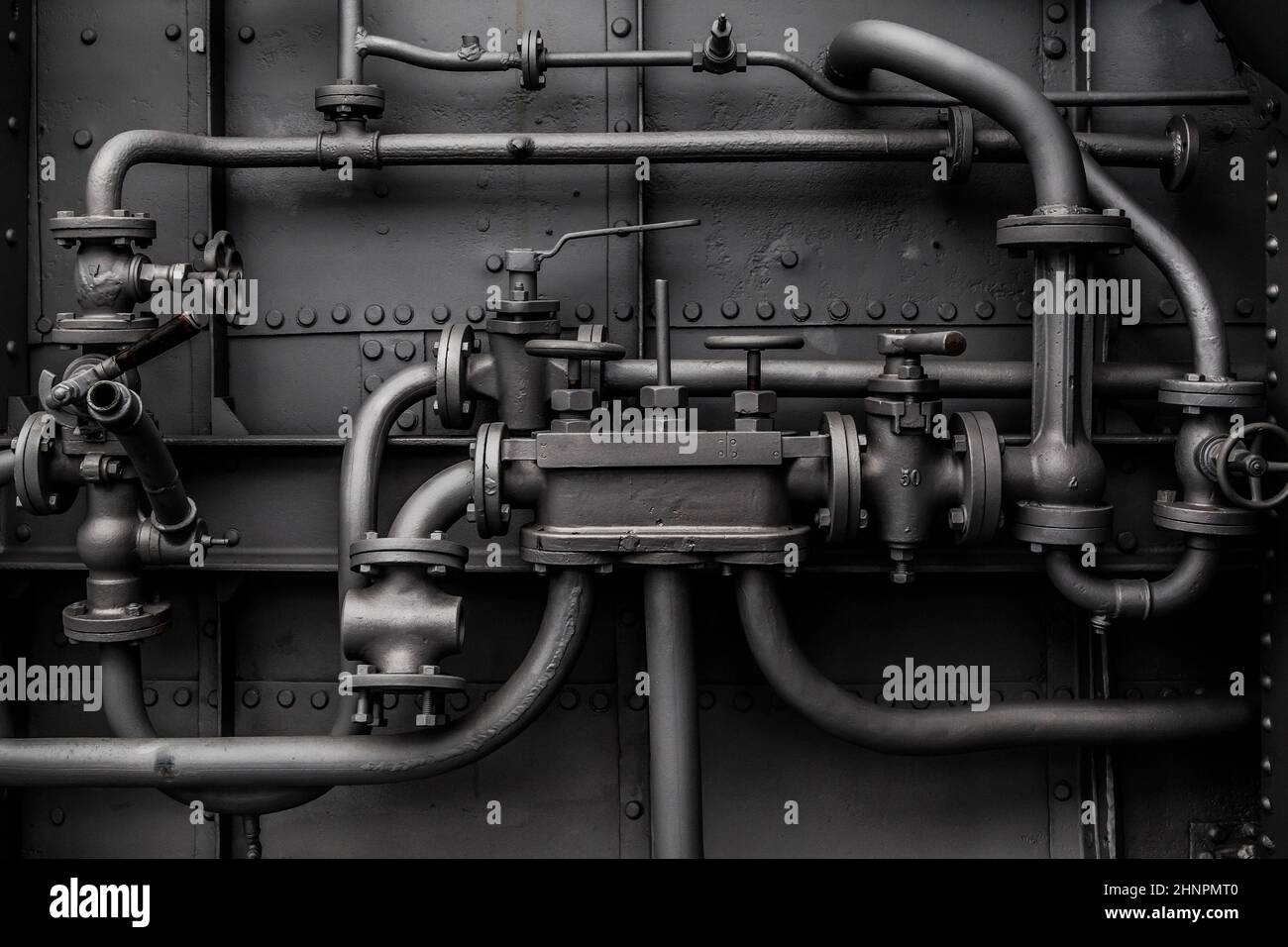 Industrial pipes and pressure valves as a background Stock Photo - Alamy