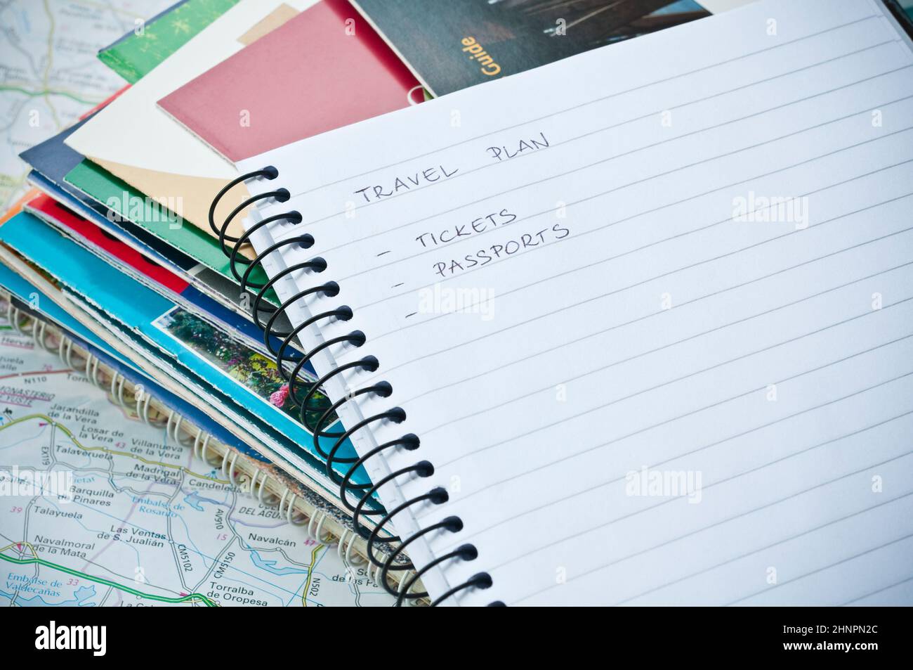 Travel plan concept with notebook, writing, map, and ballpoint pen ...