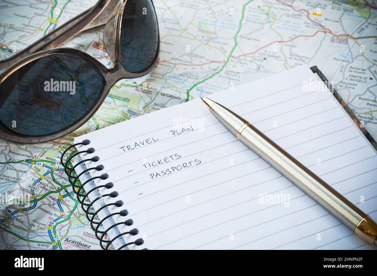 Travel plan concept with notebook, writing, sunglasses, map and ...