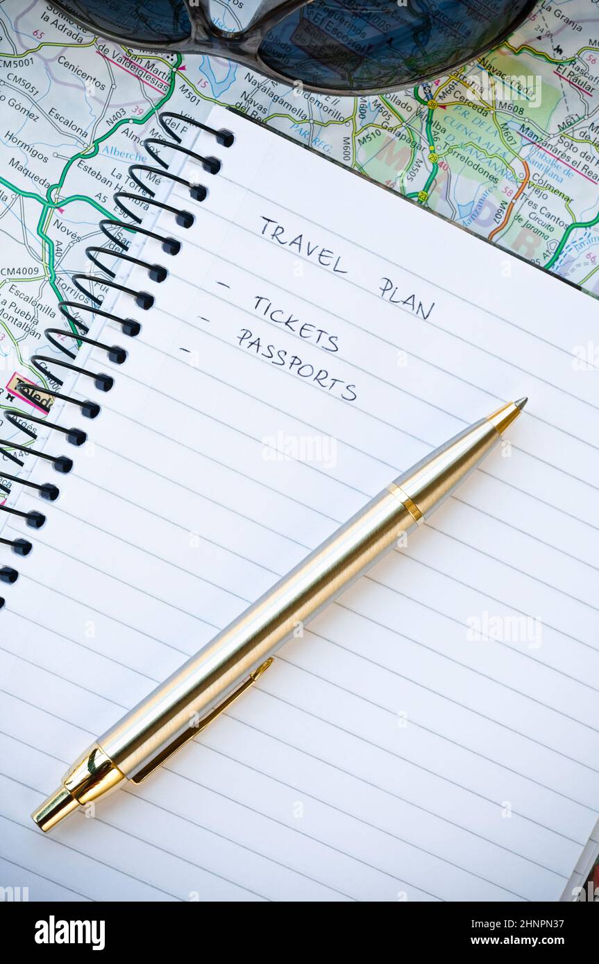 Travel plan concept with notebook, writing, sunglasses, map and ...