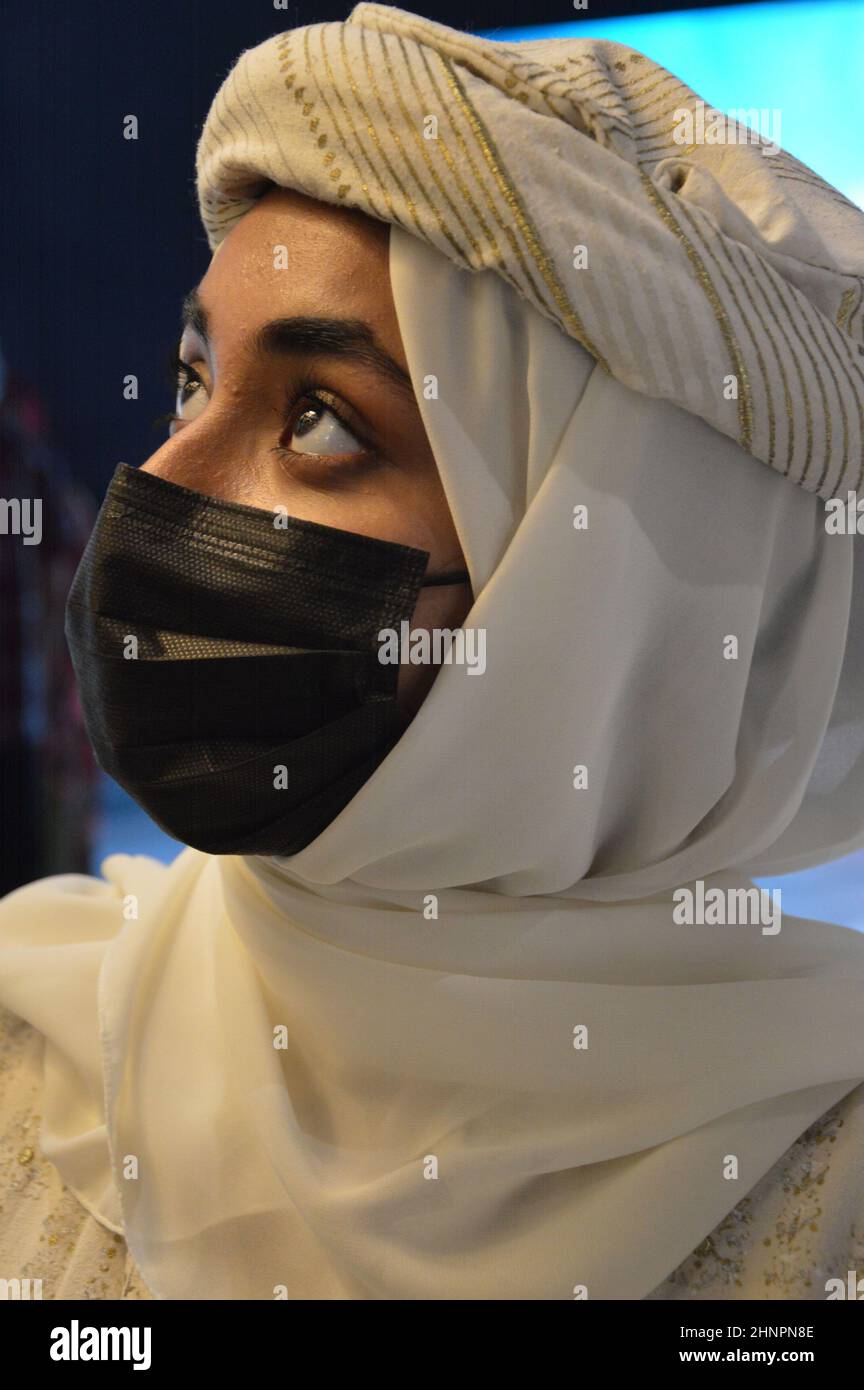 Expo staff member with face mask and traditional costume in The ...