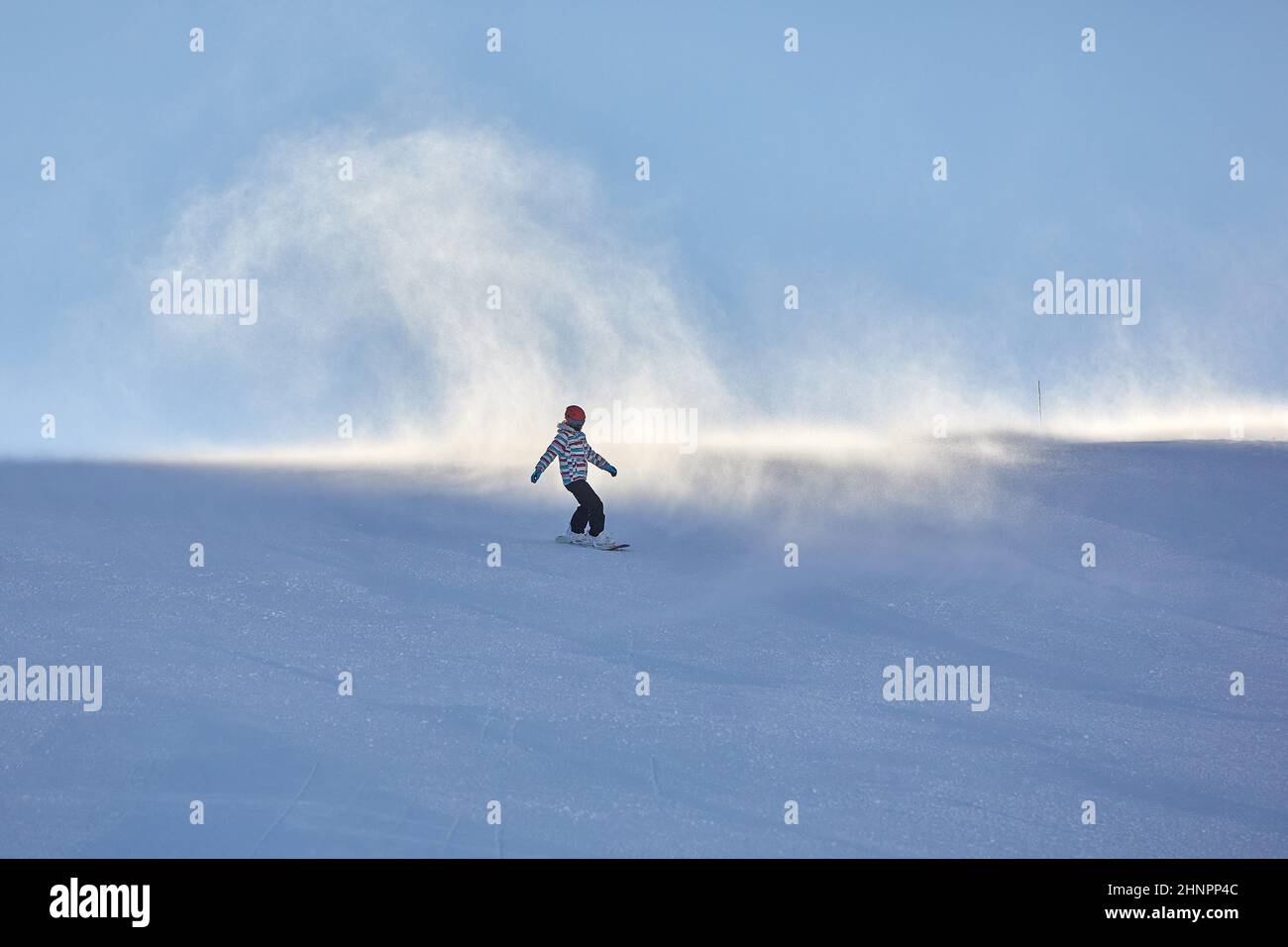 Female snowboarder fast on a slope Stock Photo - Alamy