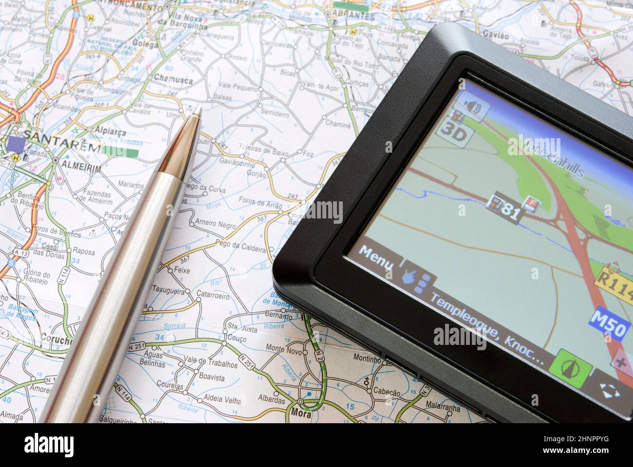 GPS global positioning device with map and ballpoint Stock Photo - Alamy