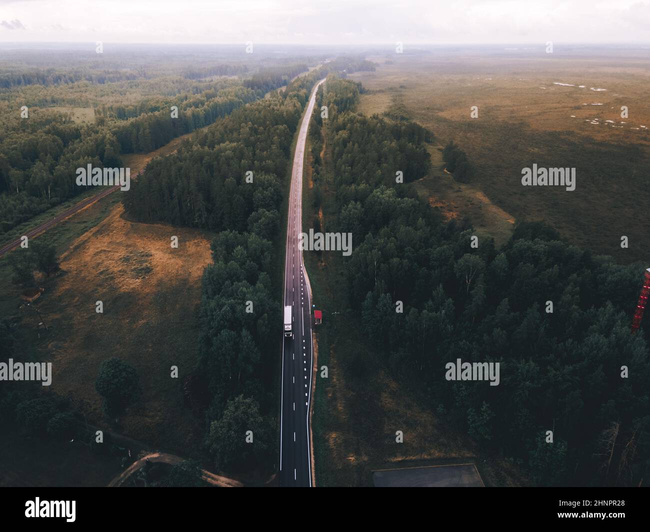 Single lane road in atvia at sunset Stock Photo - Alamy
