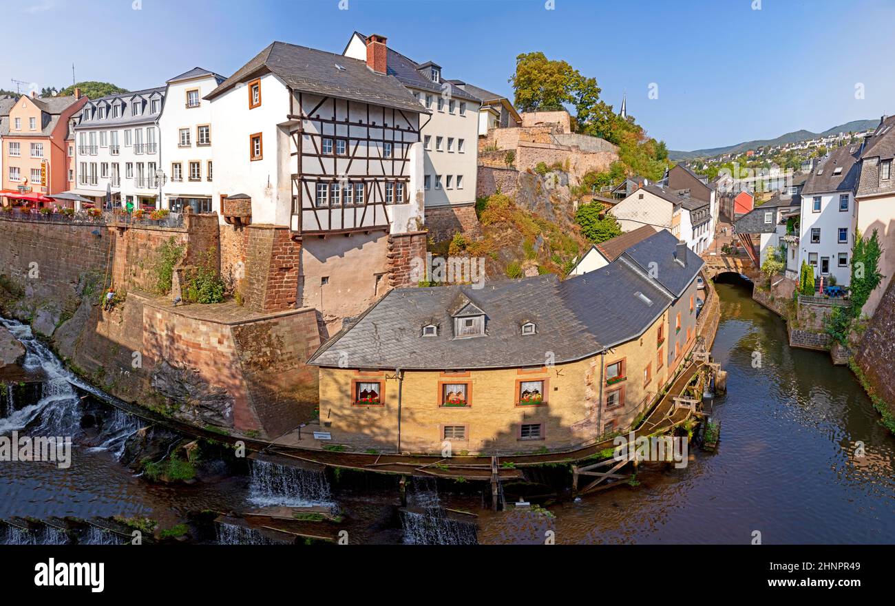 waterfall in the city center of Saarburg, Germany surrounded by houses ...