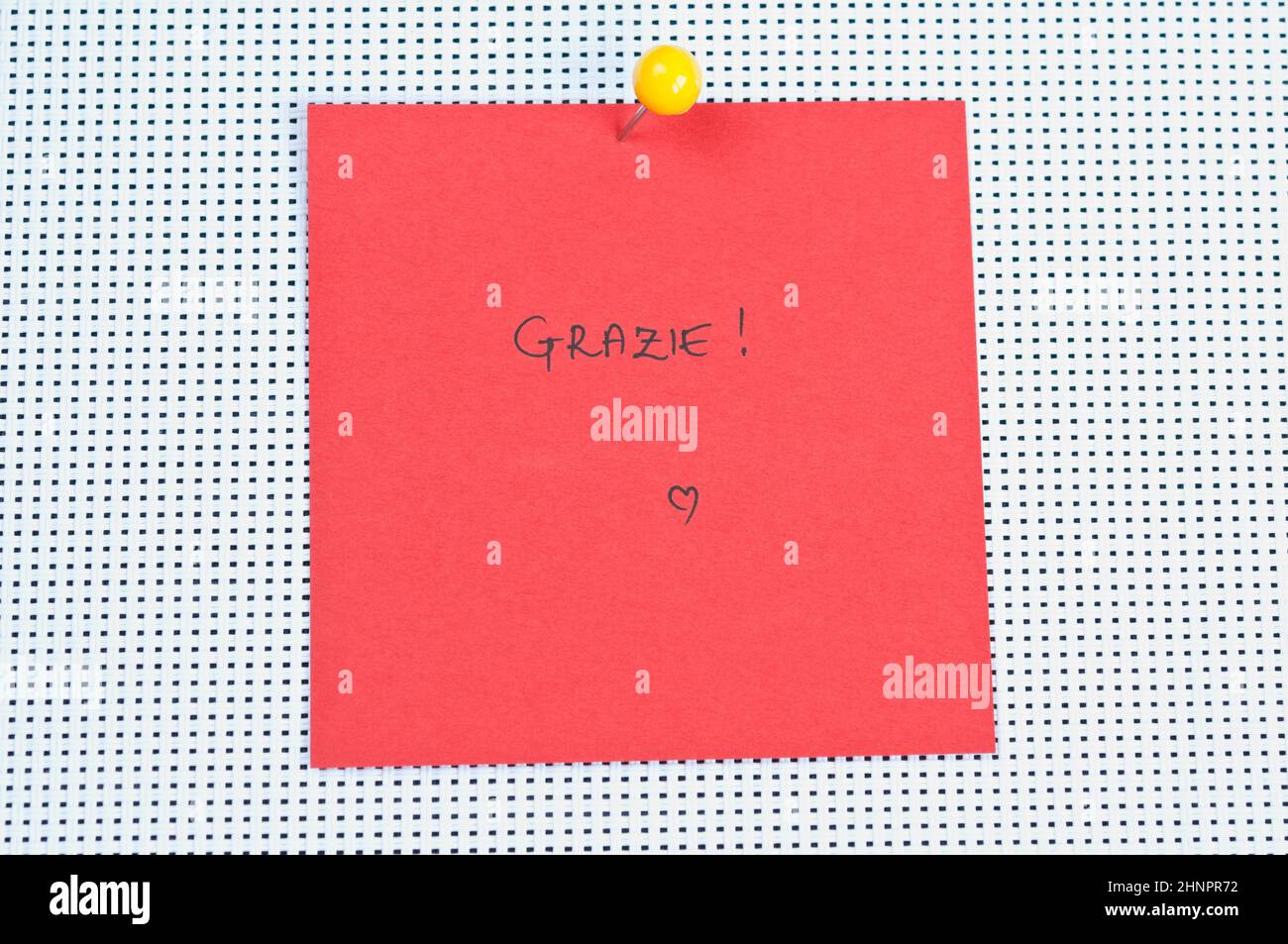 Postit note saying Grazie arranged on black and white background Stock ...