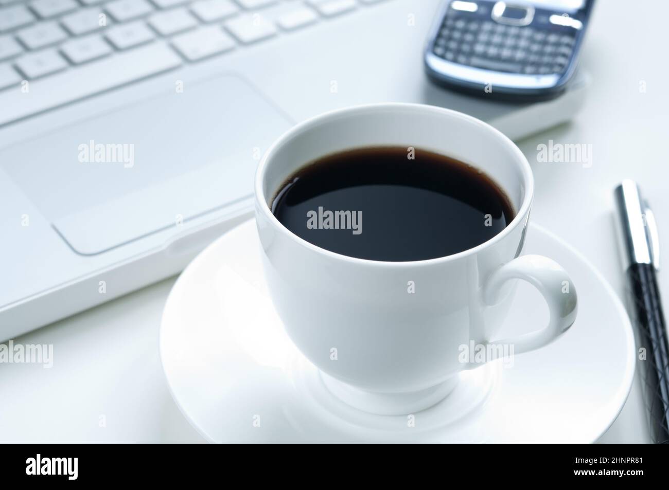Modern laptop with mobile phone and cup of coffee Stock Photo - Alamy