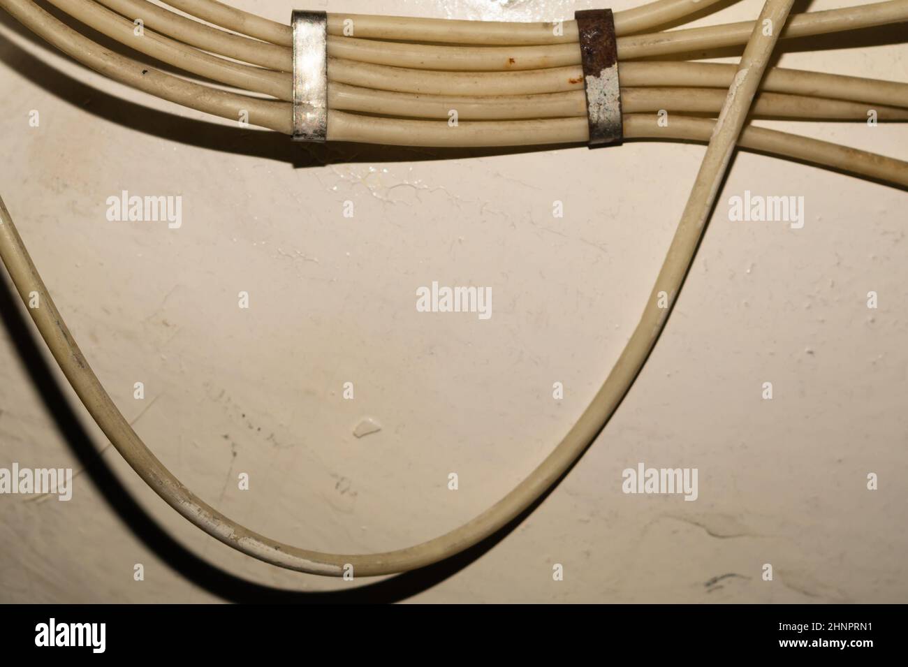 Old electrical wires or cables hanging on the wall. industrial ...