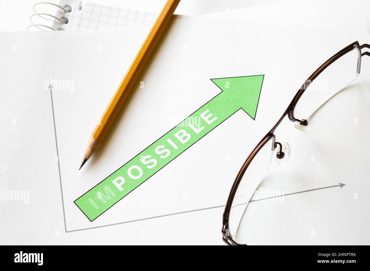 Arrow with impossible printed on white paper Stock Photo - Alamy