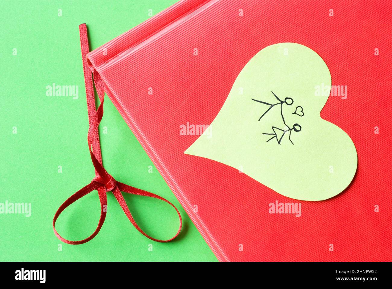 Sketch of a happy couple holding hands on a heart shaped sticky note ...