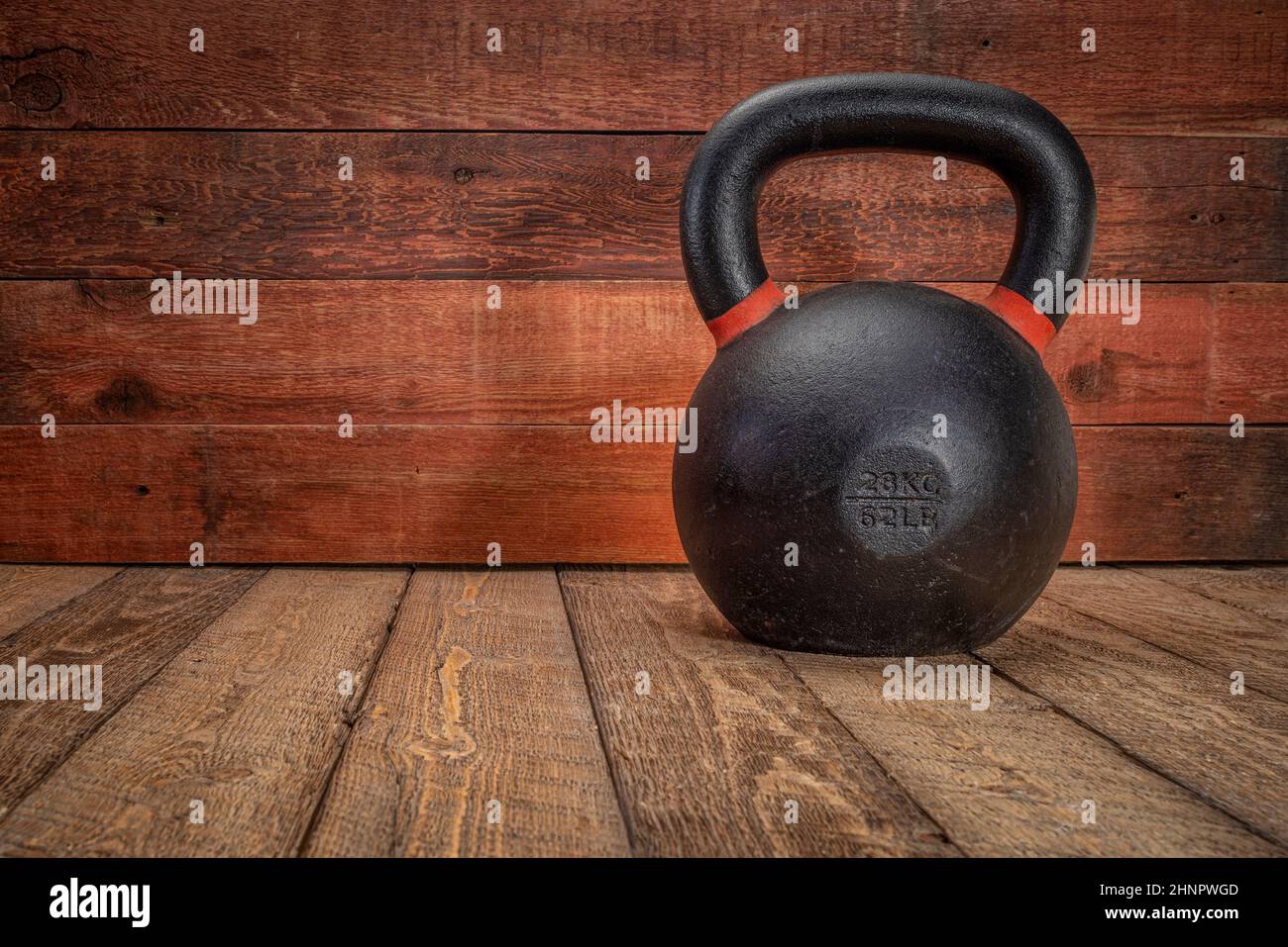 iron kettlebell on a rustic wood background with a copy space, home gym ...