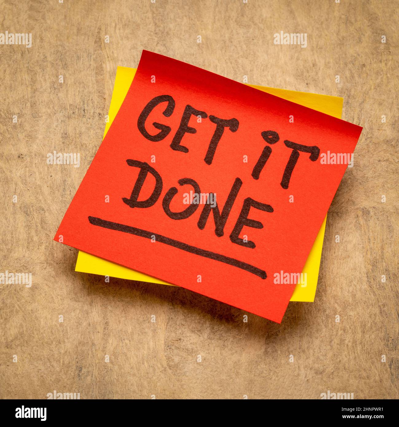 get it done advice or reminder handwriting on a sticky note, business ...