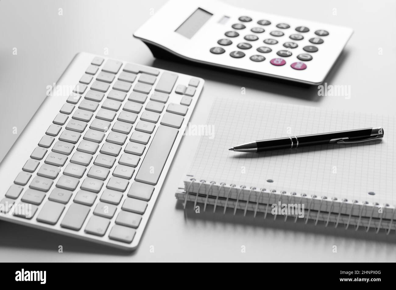 Office desk with keyboard, ballpoint, spiral notebook and calculator ...