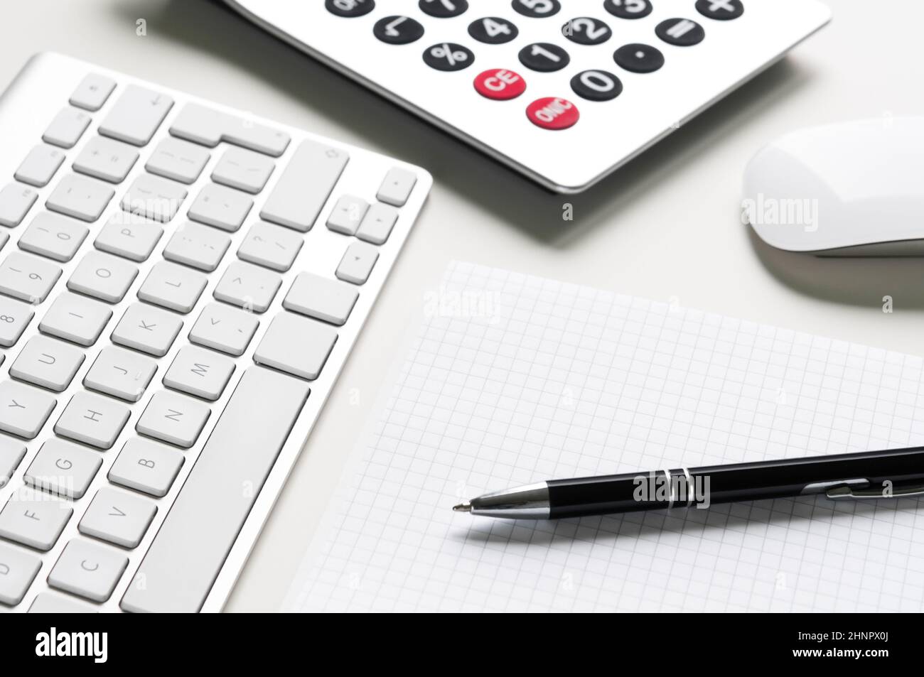 Desk with computer keyboard, calculator and ball point Stock Photo - Alamy