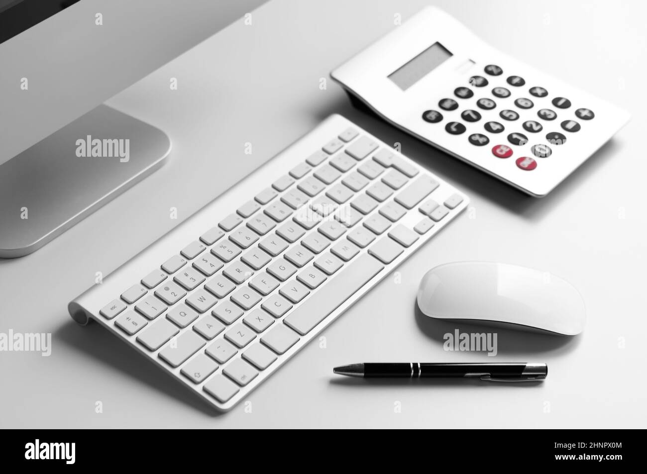 Desk with computer keyboard, calculator and ball point Stock Photo - Alamy