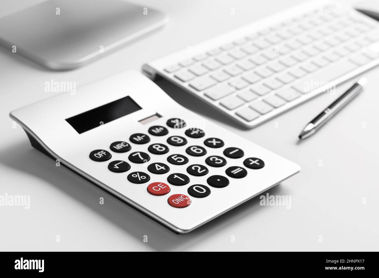 Desk with computer keyboard, calculator and ball point Stock Photo - Alamy