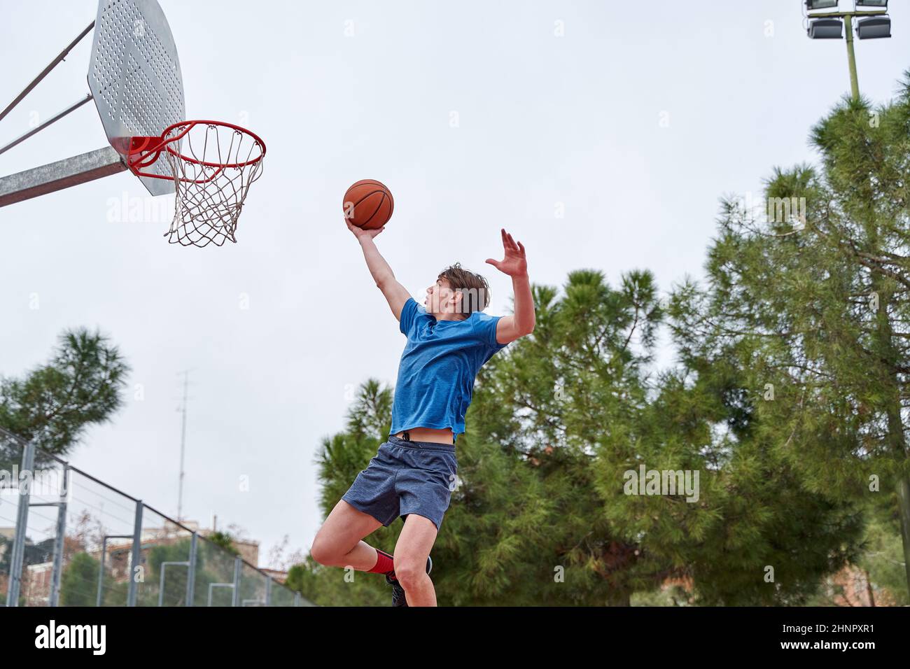 Basketball player making a dunk Stock Photo - Alamy