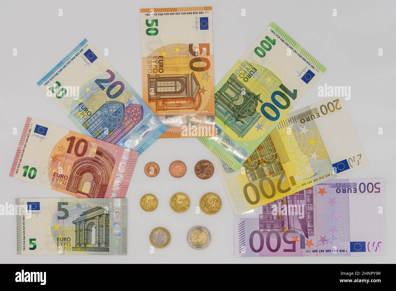 Every kind of Euro coins in the centre and banknotes disposed like an ...