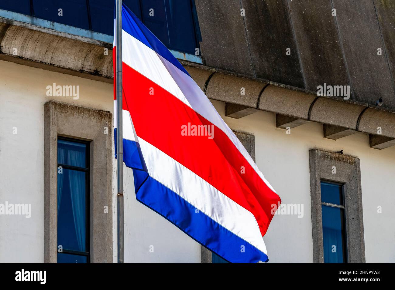 Flag of Costa Rica with old buildings behind Costa Rican flag blue ...