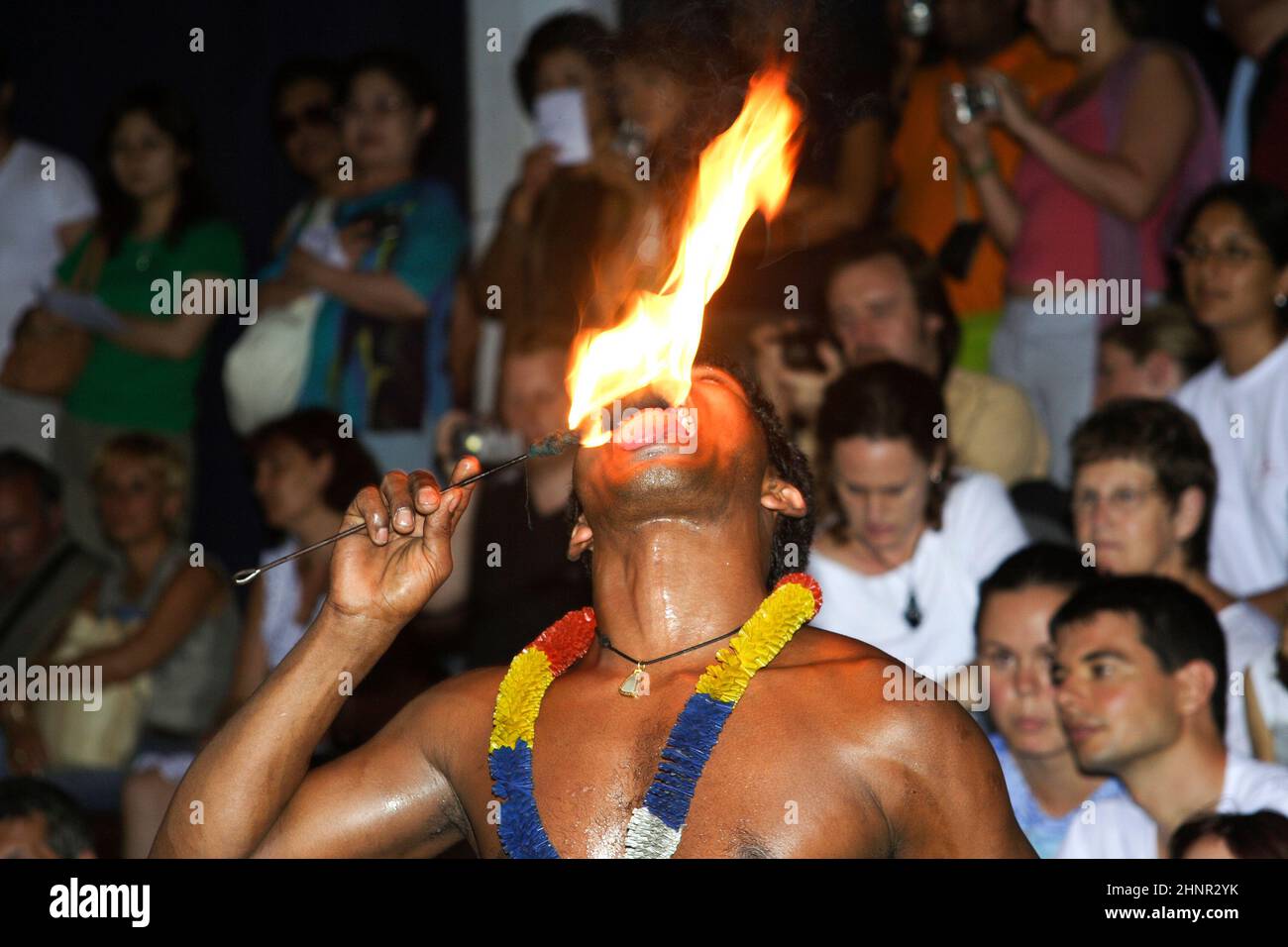 fire dancer keeps his tongue to the torch at the festival Pera Hera in ...