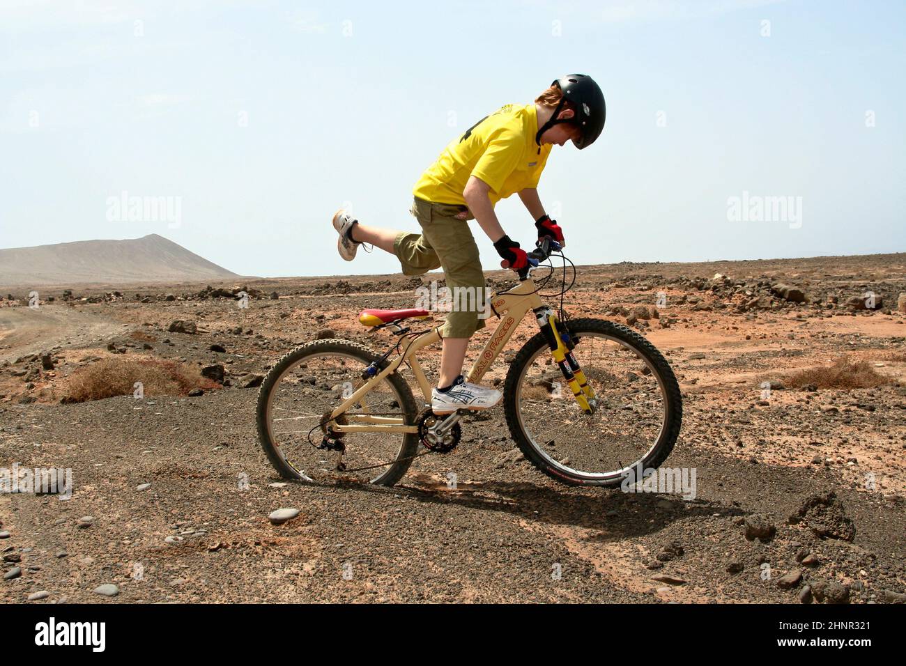 boy riding his mountainbike offroads and doing tricks Stock Photo - Alamy