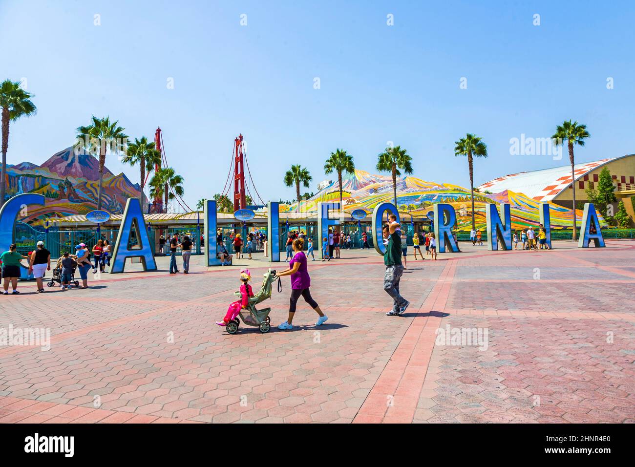 people visit disneyland and walk over commemorative bricks with names ...