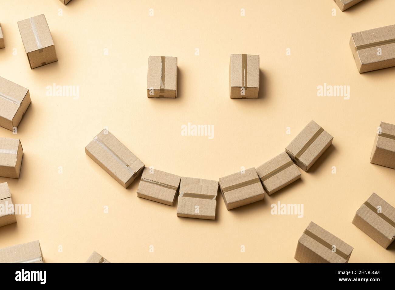 Smiling face from cardboard boxes on a light brown background Stock ...