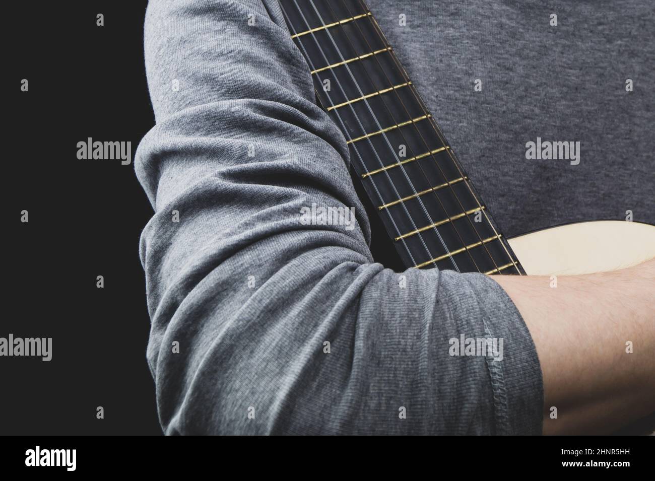 Man holds acoustic guitar. string instrument Stock Photo - Alamy