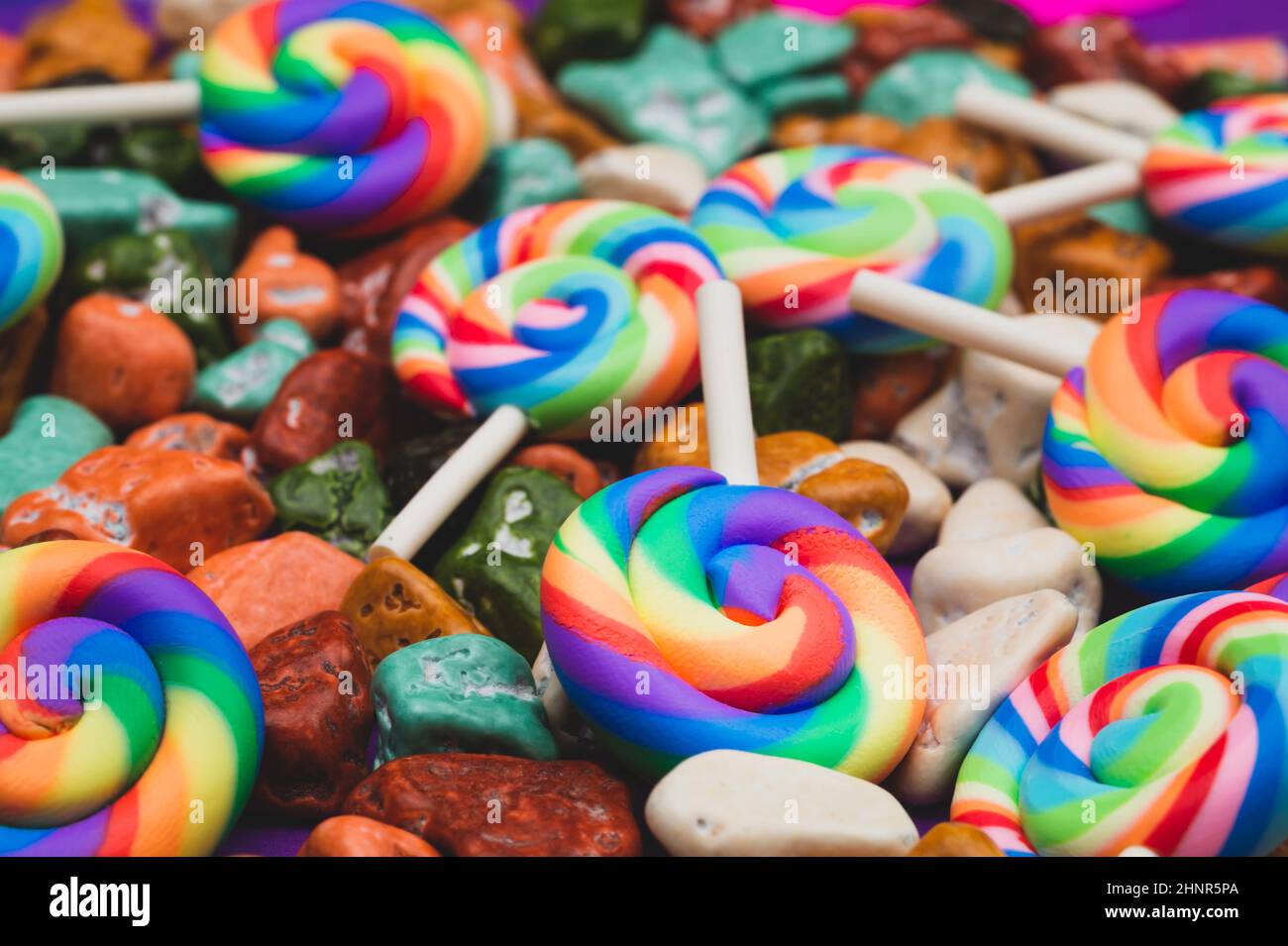 Lollipops and candy pebbles. spiral candies and sweets in the form of ...