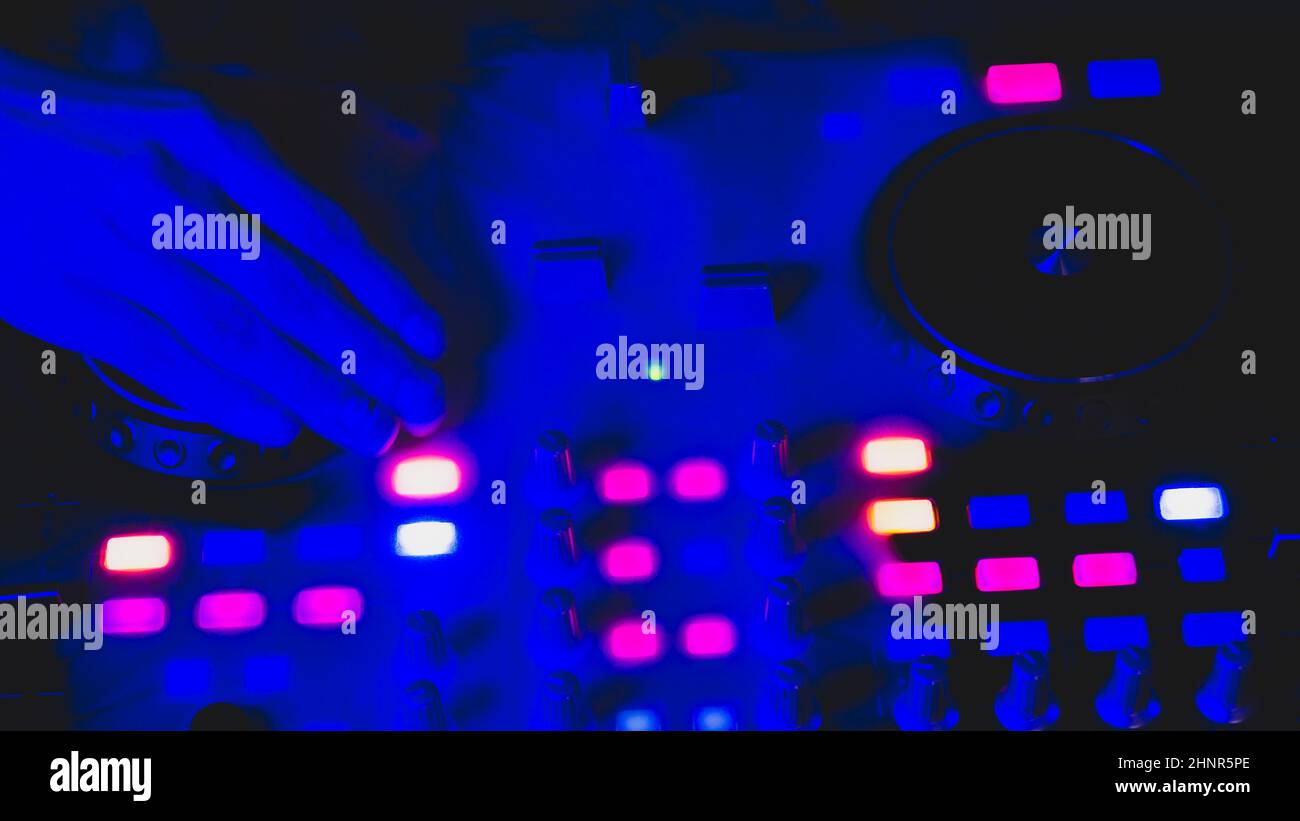 DJ plays music. sound mixer controller with knobs and sliders close up ...