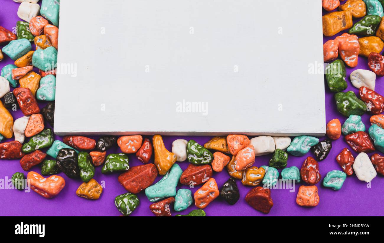 Candy pebbles. sweets in the form of colored stones. frame made from ...