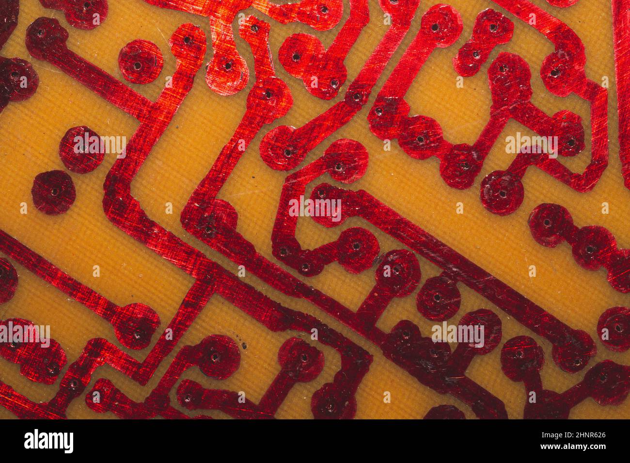 Handmade circuit board with red soldered tracks. industrial background ...