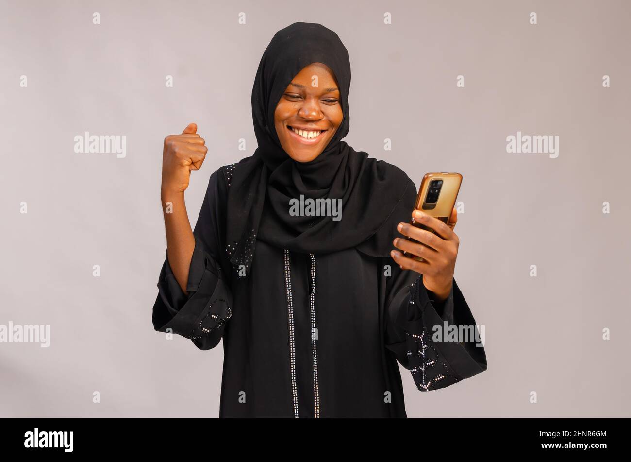 excited muslim lady isolated over white background Stock Photo - Alamy