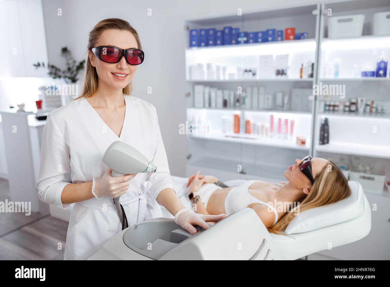 Woman beautician using laser epilation machine in beauty salon Stock ...