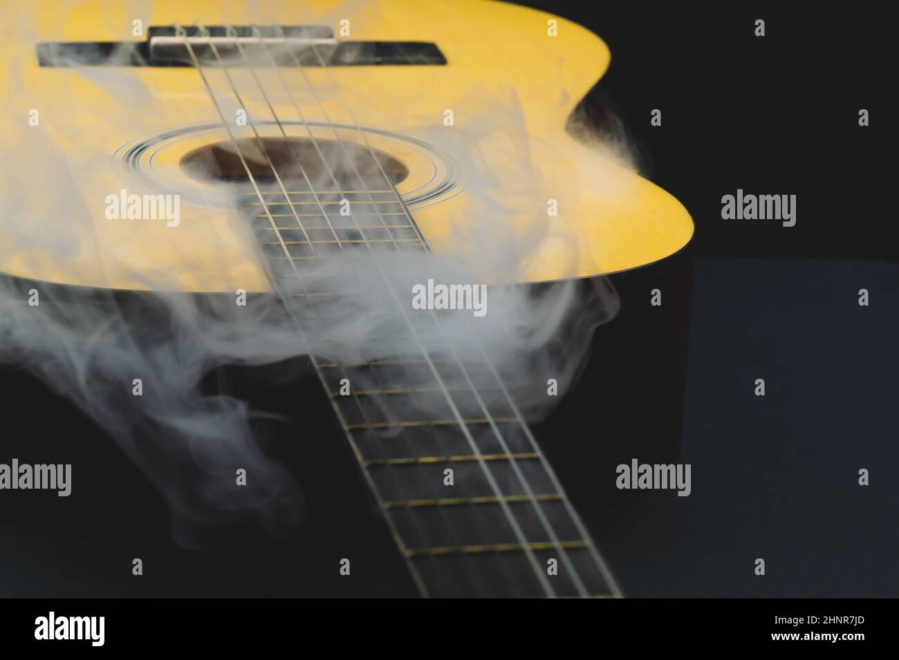 Guitar in smoke close up. acoustic musical instrument. strings on the ...