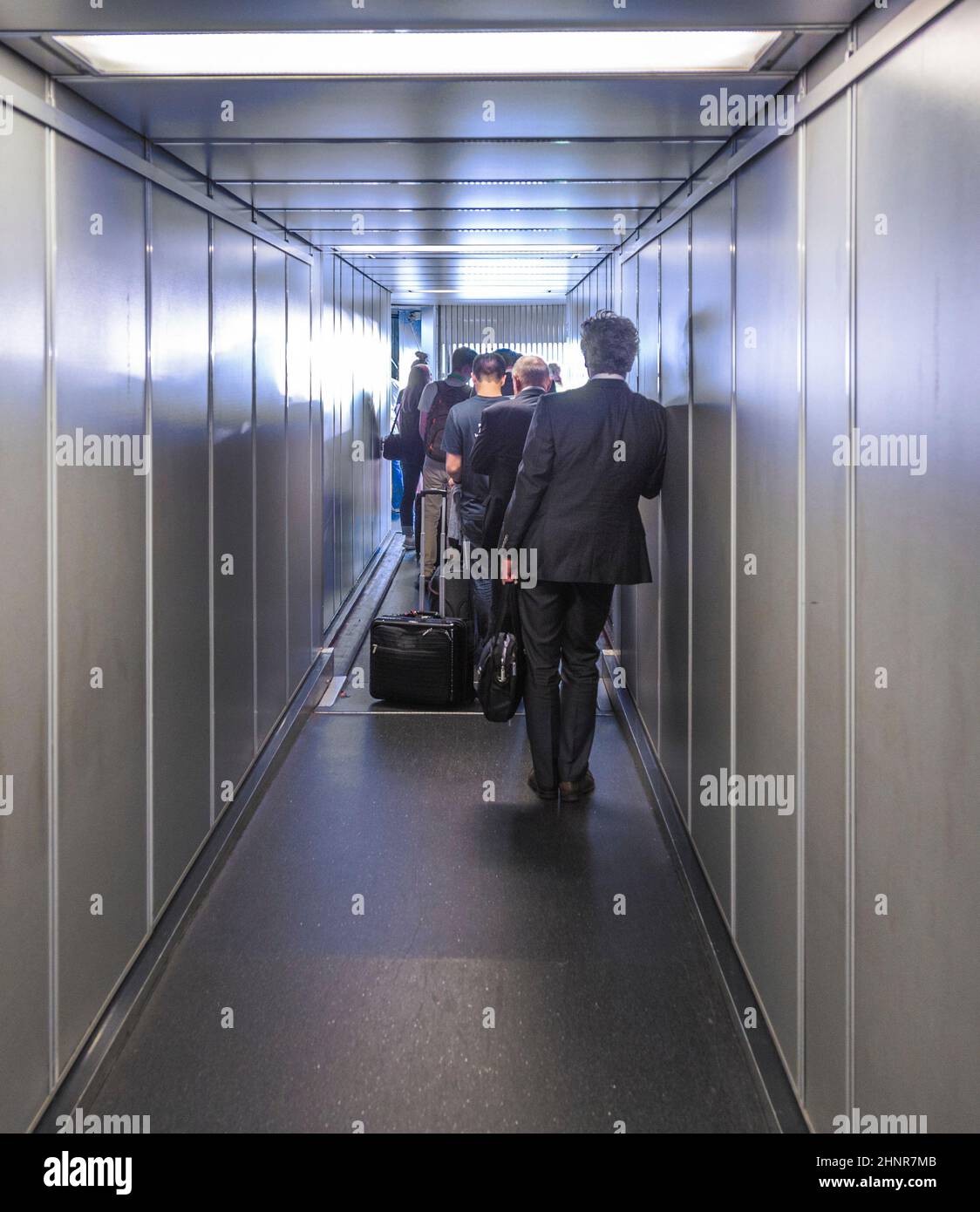 people enter the aircraft via a passenger bridge Stock Photo - Alamy