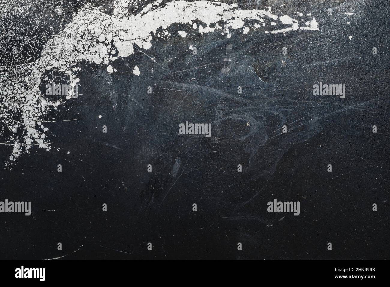 Black steel plate with white paint spots. metal surface with paint ...