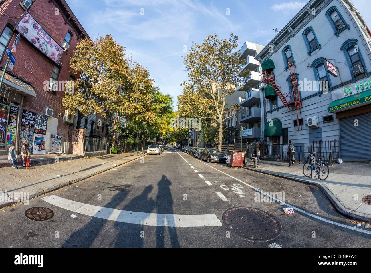 typical street scene with people in early morning in New York, Brooklyn ...