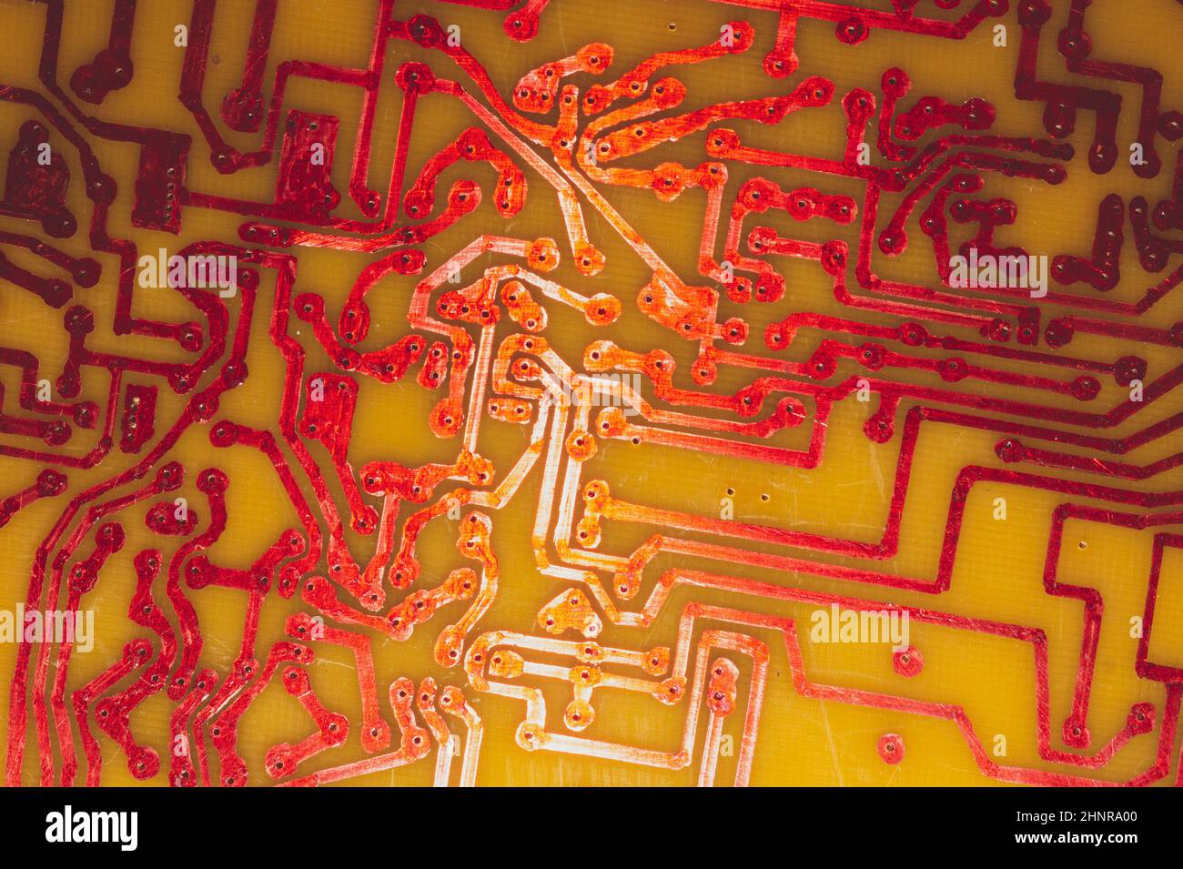 Handmade circuit board with red soldered tracks. industrial background ...