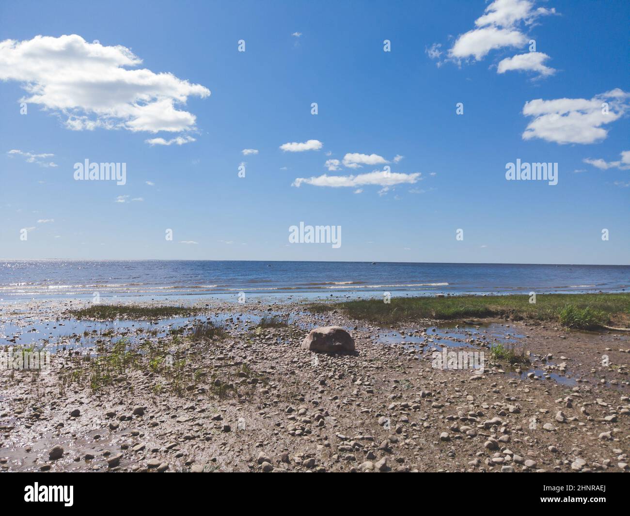 Shore of the sea. seascape with horizon line. sky with clouds. silt ...