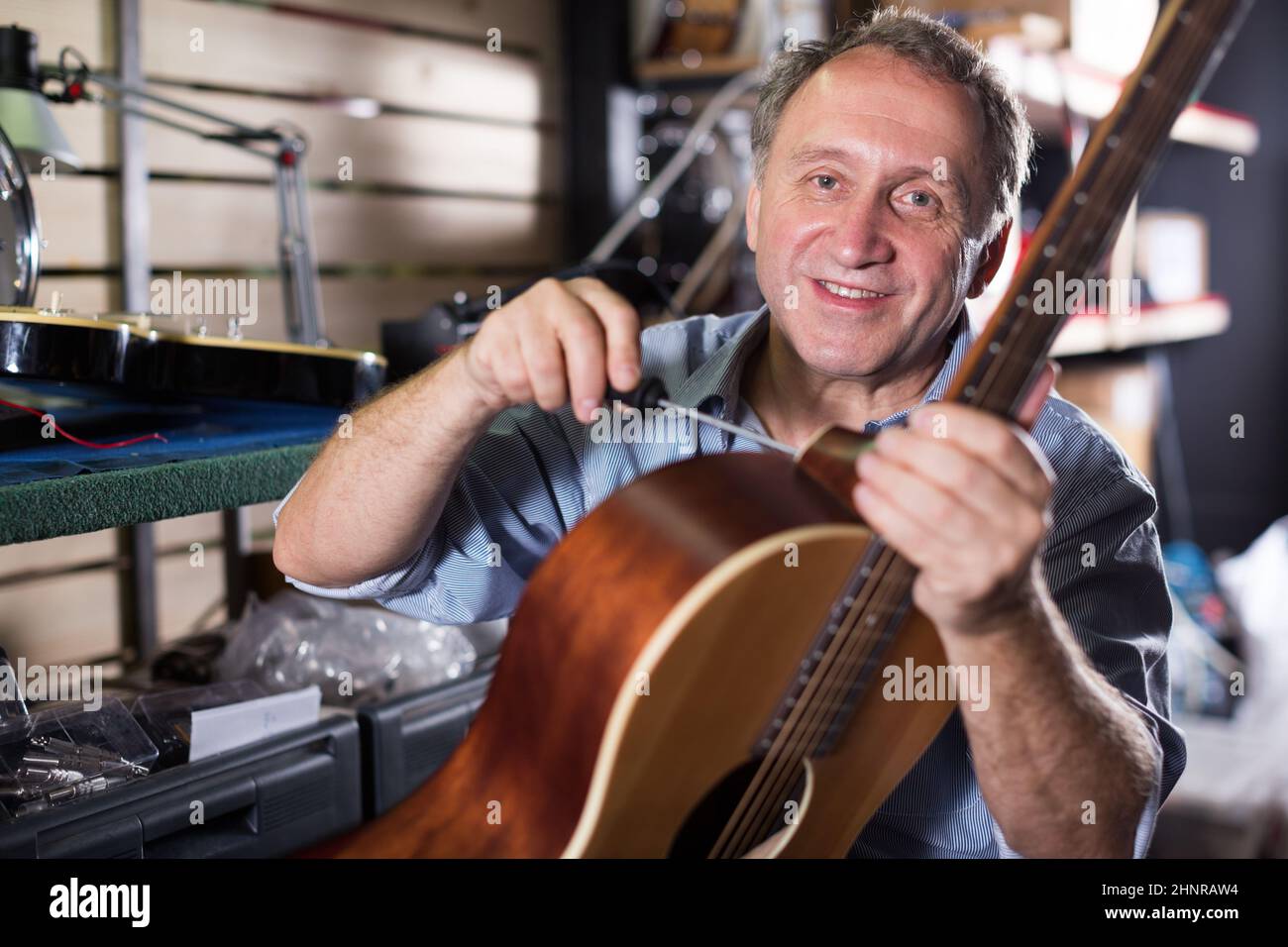 Music master is repairing music instruments Stock Photo - Alamy