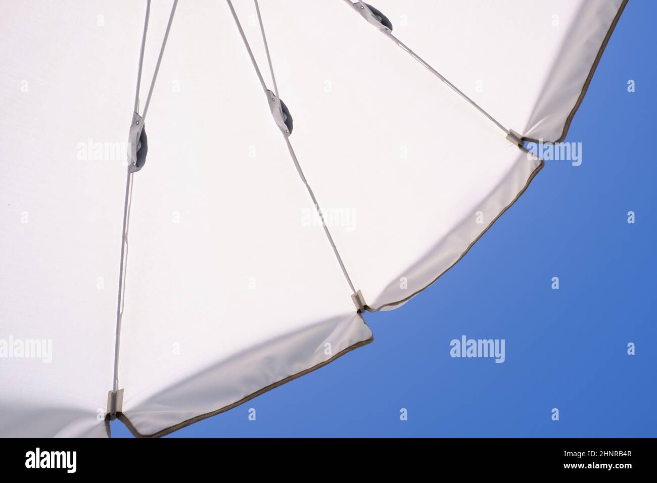 white parasol in the day with sun and clear blue sky Stock Photo - Alamy